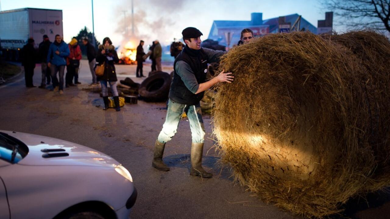 Angry farmers blockade French town to protest against falling prices