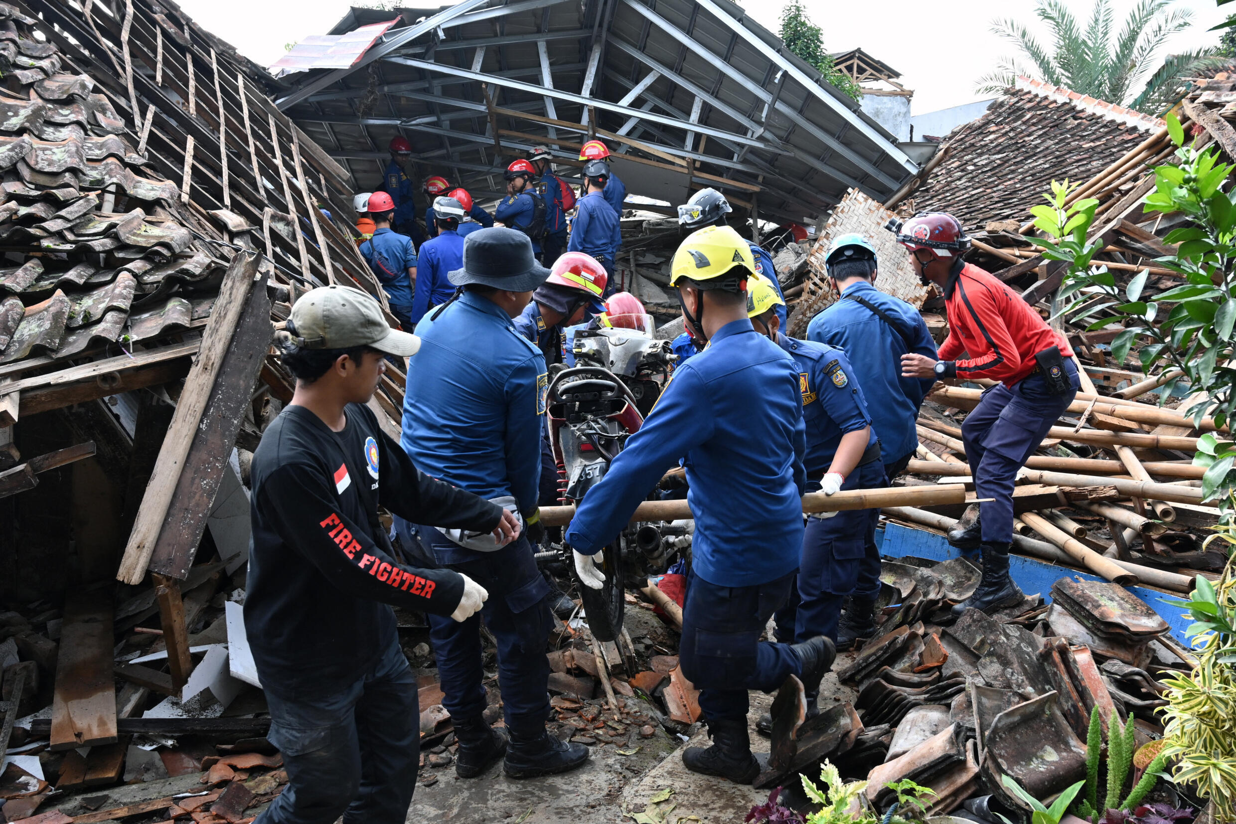 Rescuers in Indonesia pull six-year-old boy from rubble after deadly quake