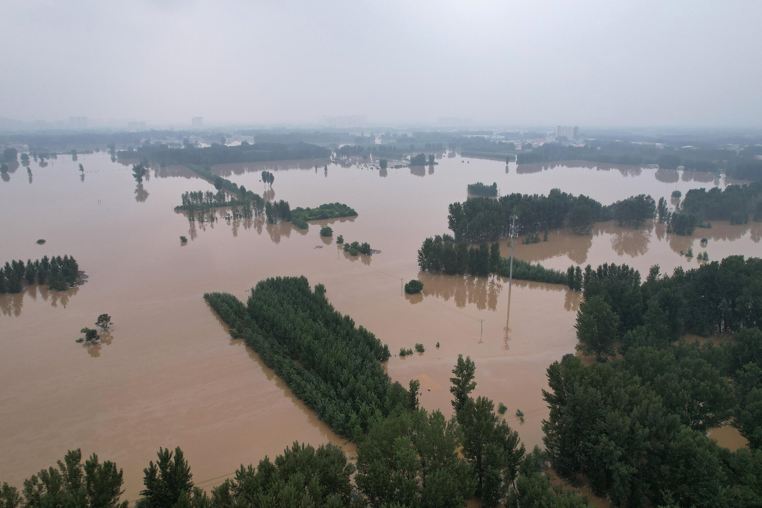 Streets become rivers as Beijing records heaviest rain in 140 years