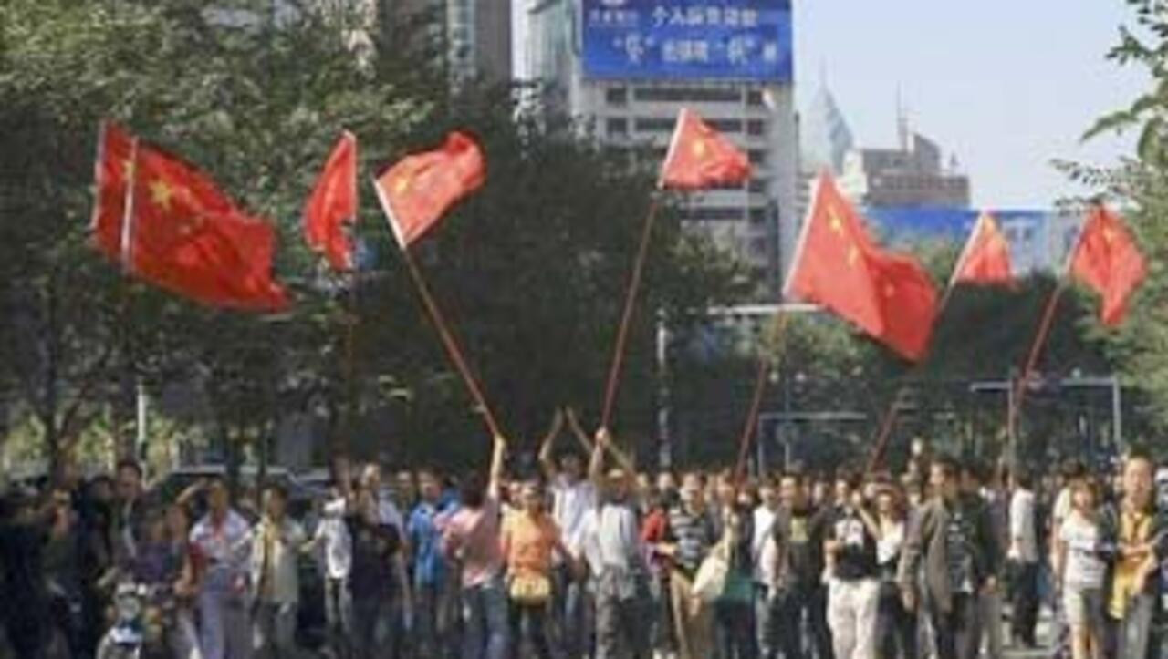 Urumqi in lockdown after tens of thousands protest 'syringe' attacks