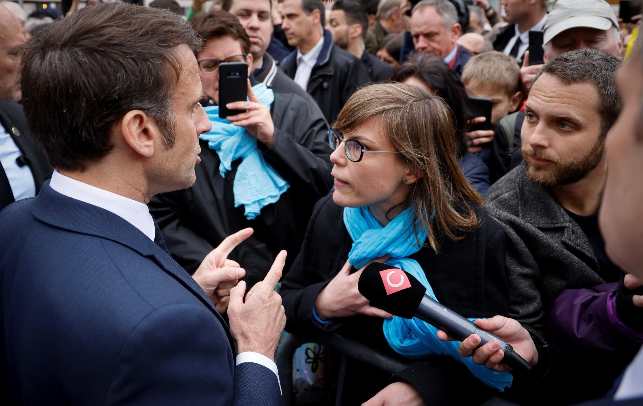 Macron booed by angry French after signing pensions reform