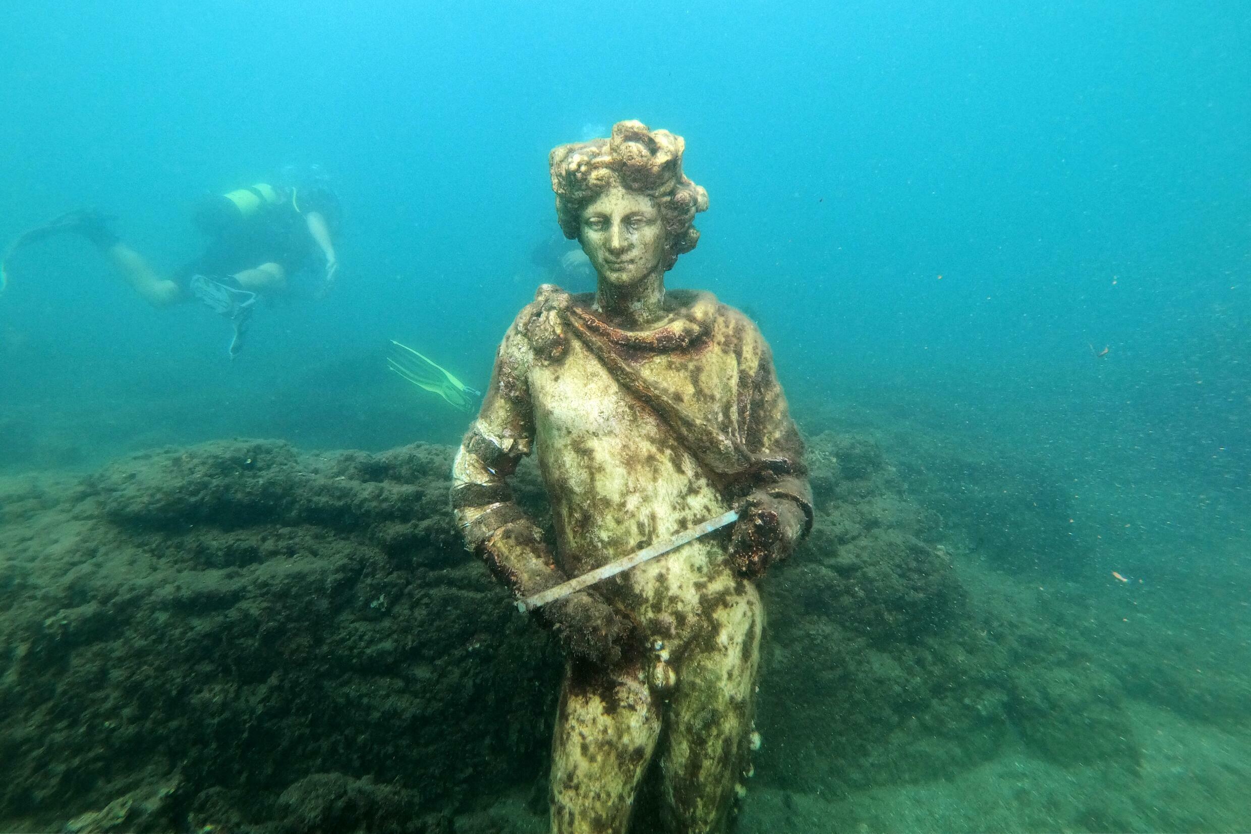 Tourists enjoy the underwater ruins of a Roman coastal resort