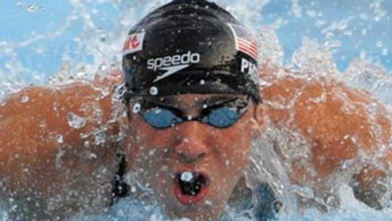 Phelps takes gold and breaks world record in 100m butterfly final