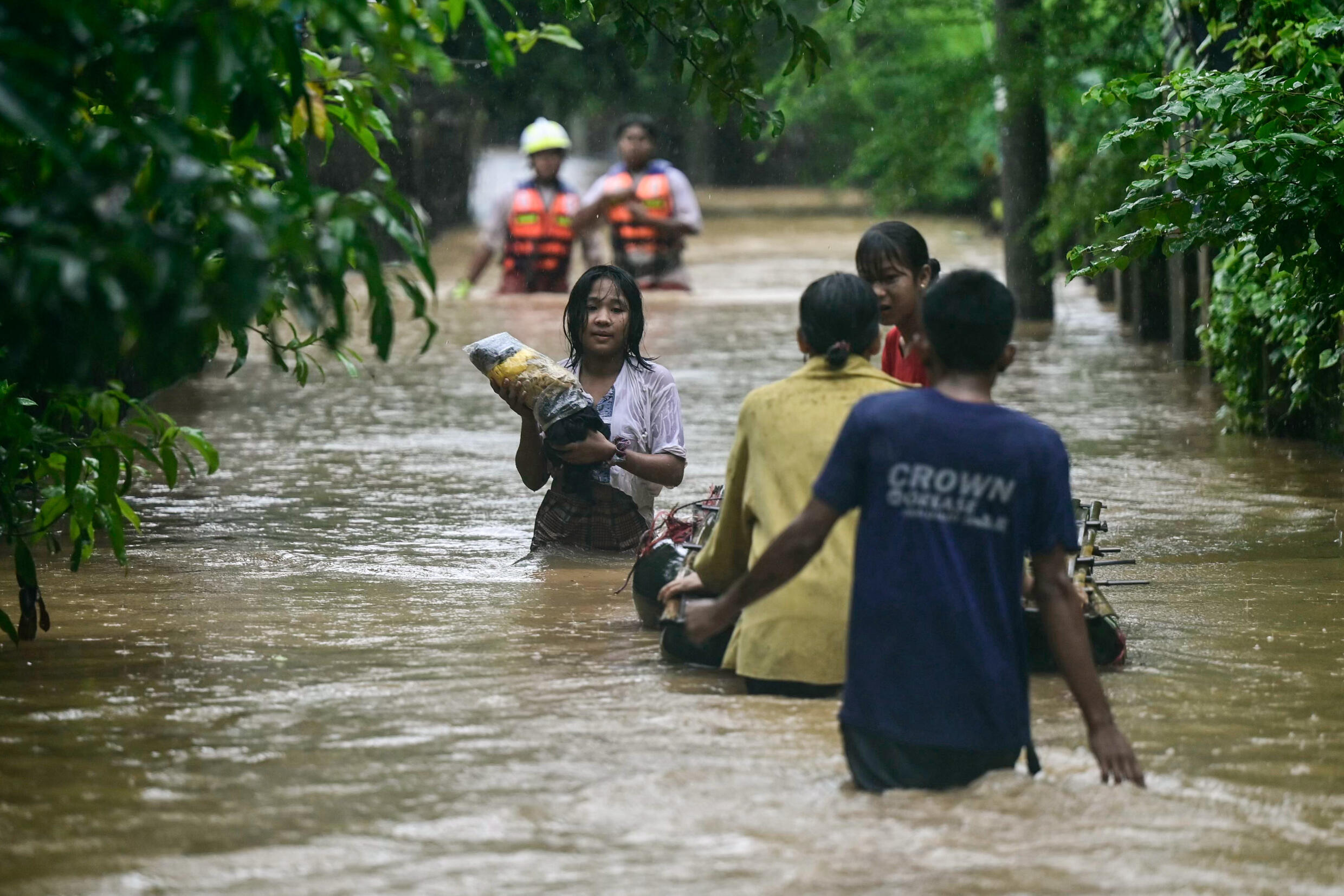Myanmar residents flee deadly floods in boats and on makeshift rafts
