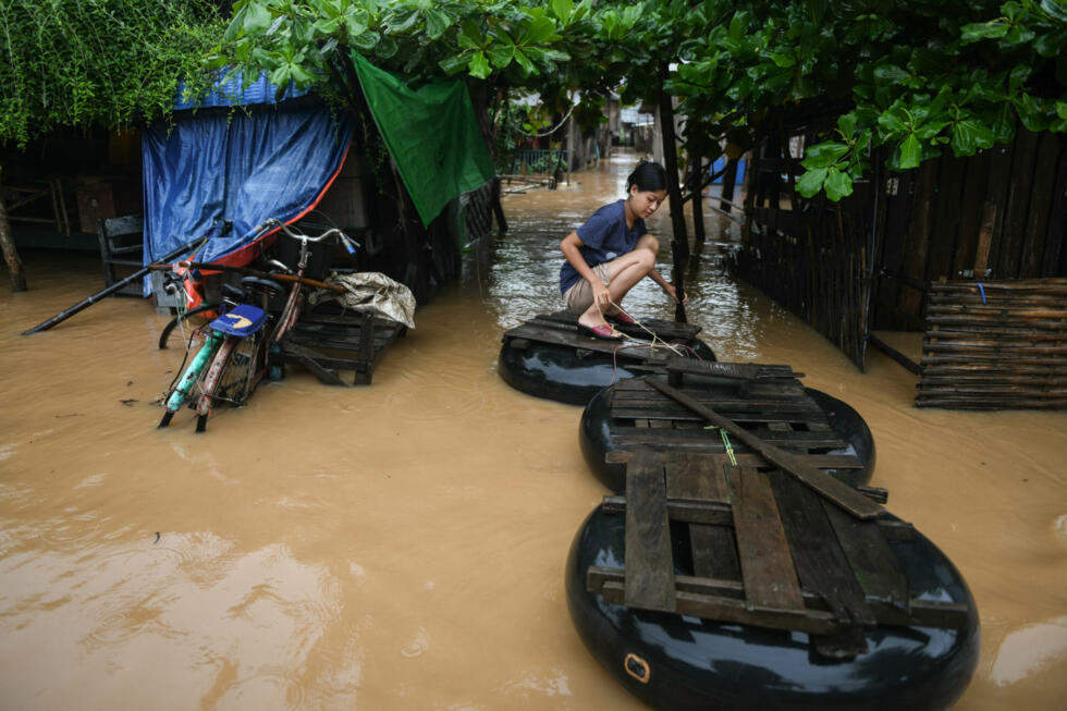 Myanmar residents flee deadly floods in boats and on makeshift rafts