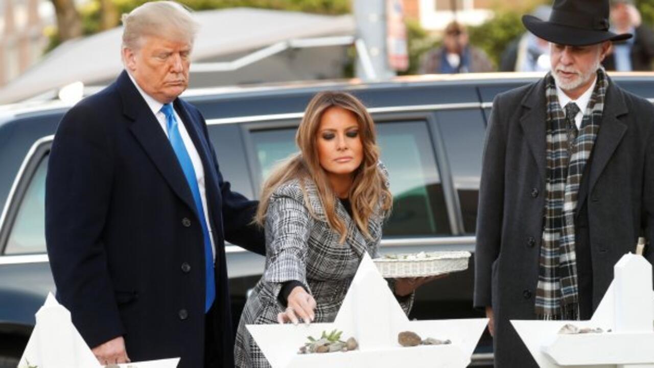 Trump visits Pittsburgh to console but stirs anger among protesters