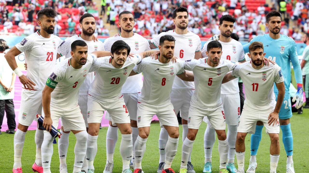 Iranian players perform the national anthem before facing Wales ...