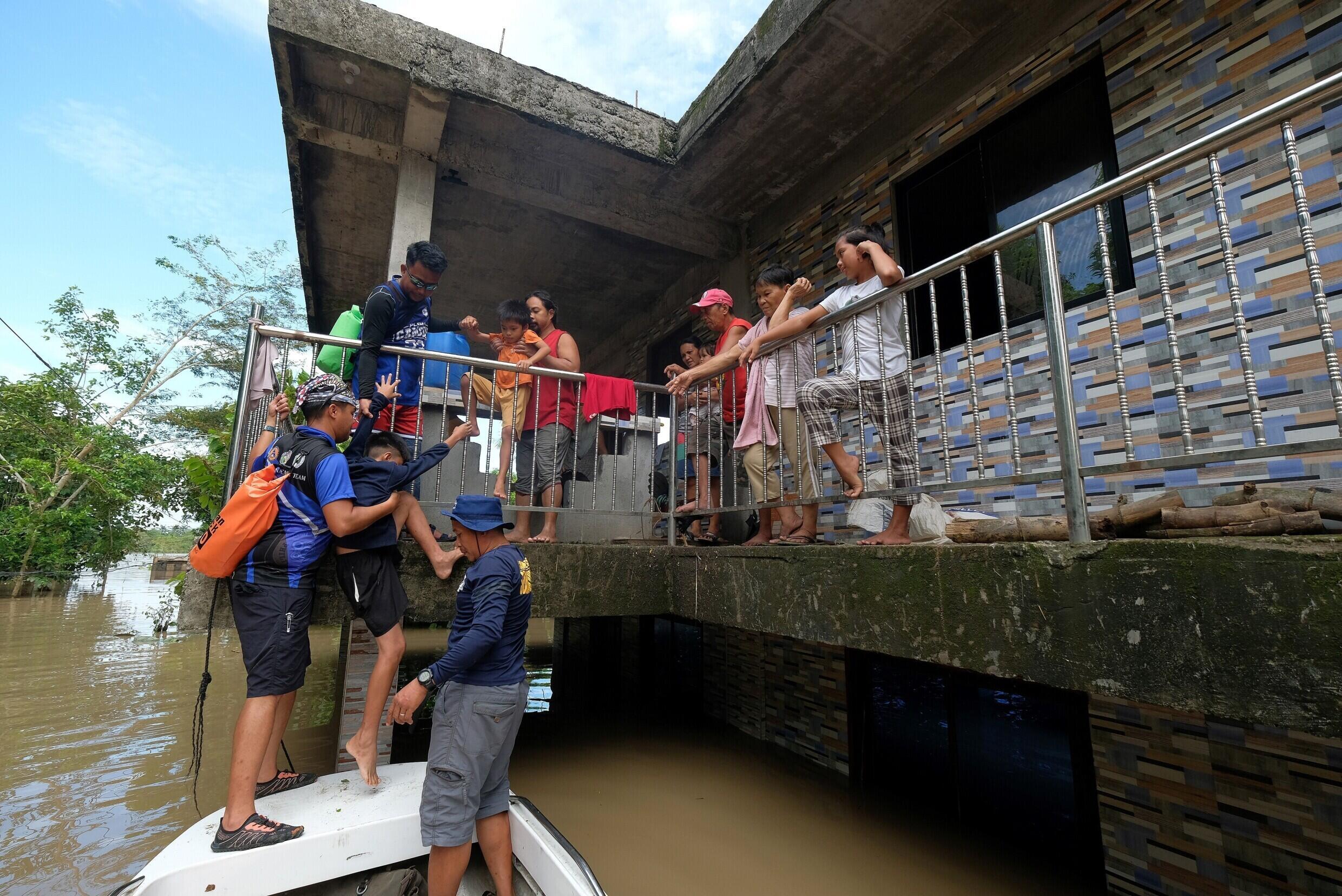 Philippine rescuers battle floodwaters to reach stranded