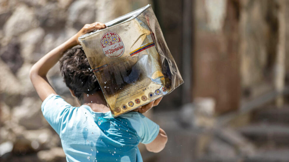 Children in war-scarred Yemen line up for water, not school