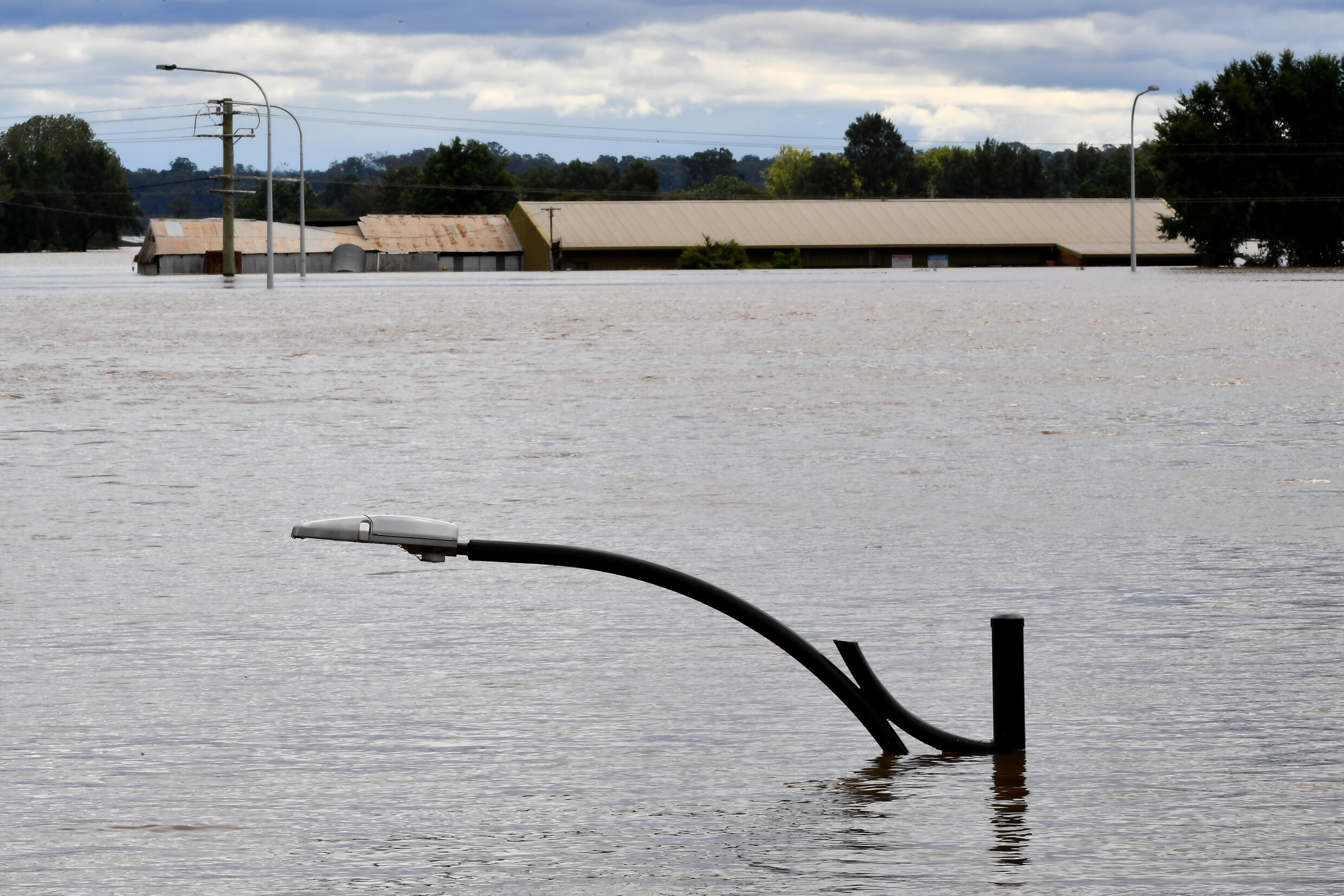 Protesters rally as Australian PM tours flood disaster