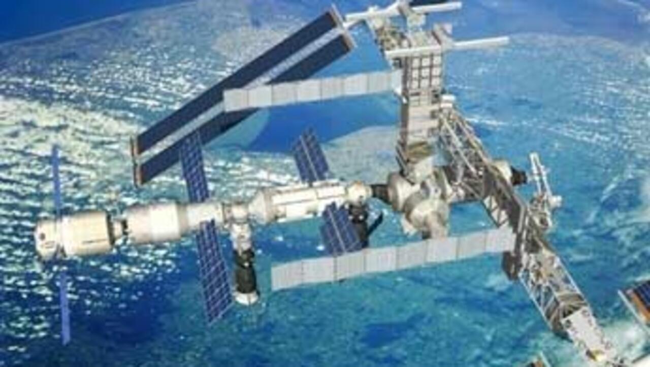 American Richard Garriott and new crew dock with space station
